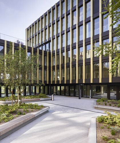 the-fa-ade-of-the-building-consists-of-a-mix-of-dark-brown-and-gold